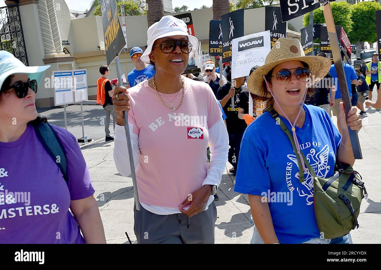 Actor Aisha Tyler, center, and fellow picketers carry signs outside ...