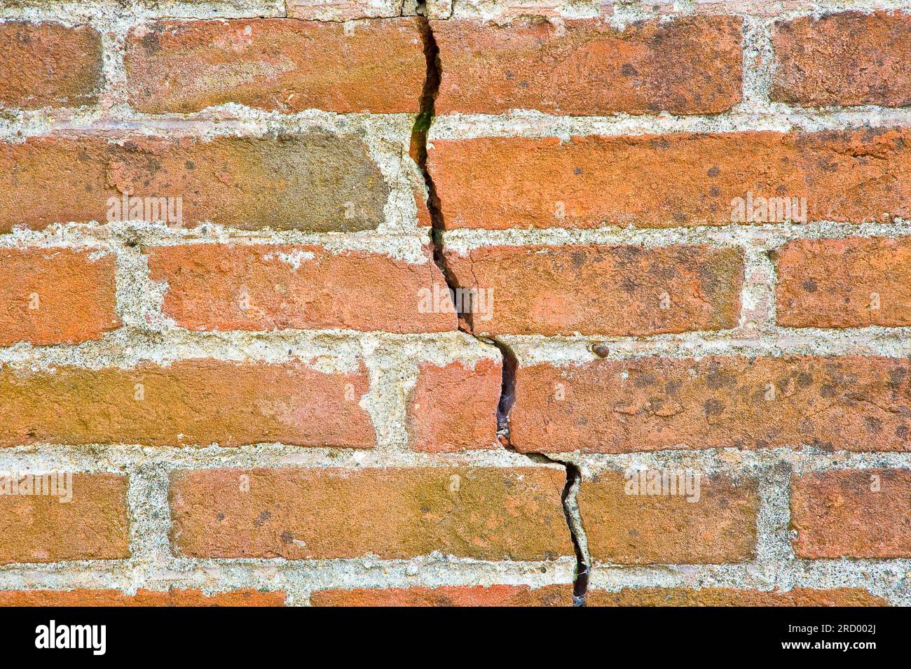 Old wall built with bricks cracked and damaged due to structural ...
