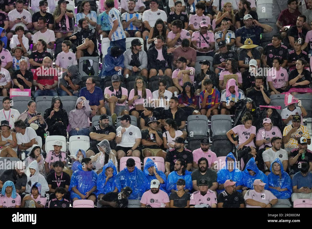 Fans sit in rainy stands as they await the start of a celebration to ...