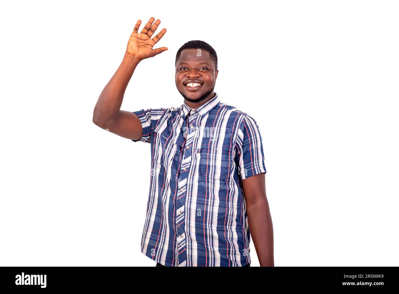 portrait of a satisfied handsome young man waving while smiling at the ...