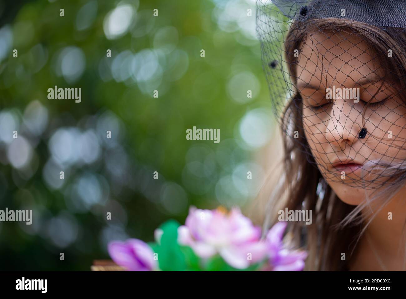 Close-up of a grieving young woman wearing a mourning veil (symbol ...