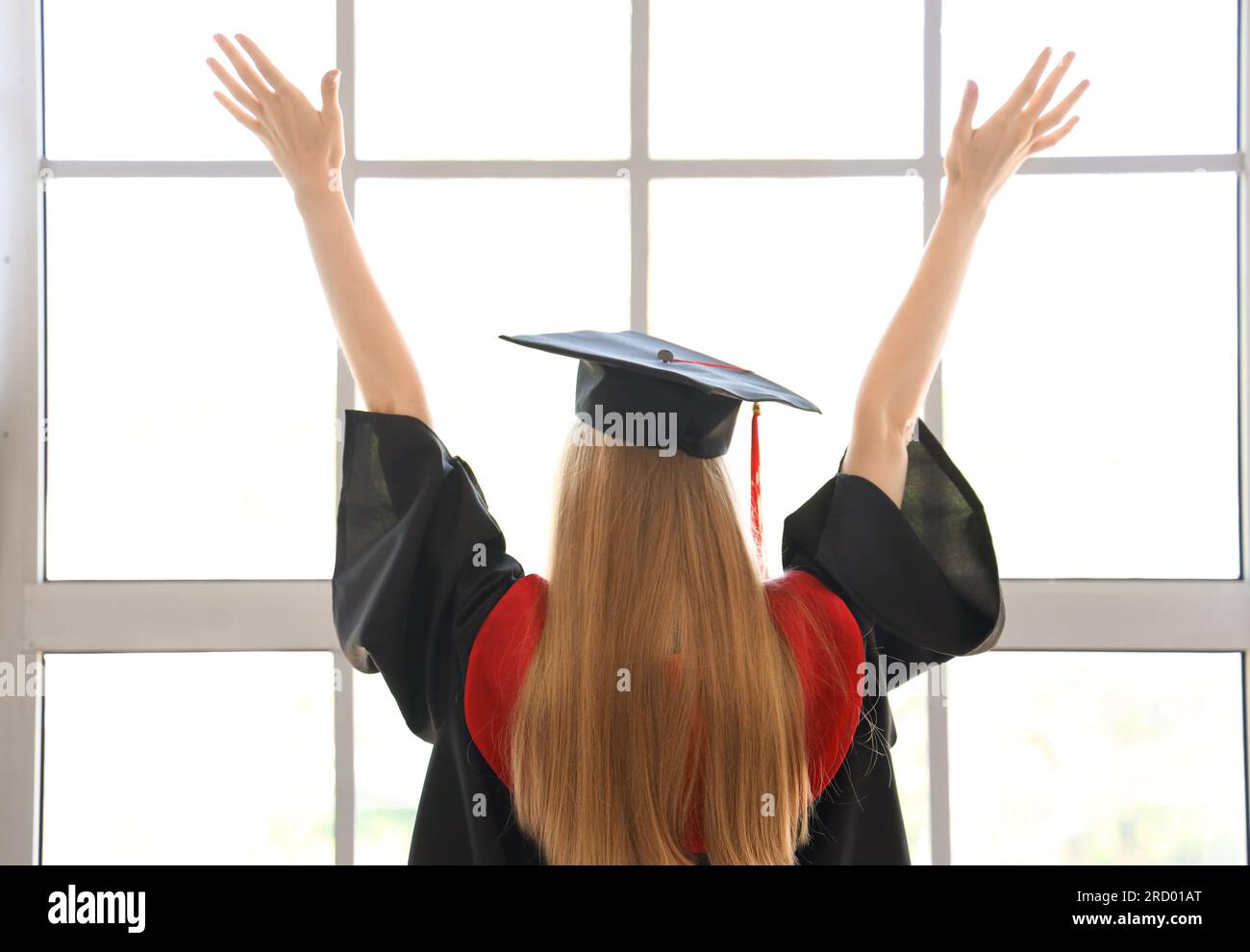 Female graduate student near window in room, back view Stock Photo - Alamy