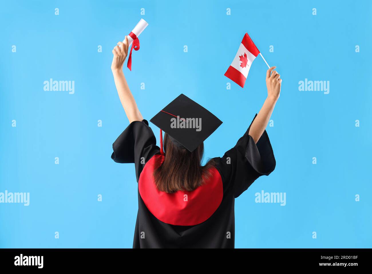 Female graduate student with diploma and Canadian flag on blue ...