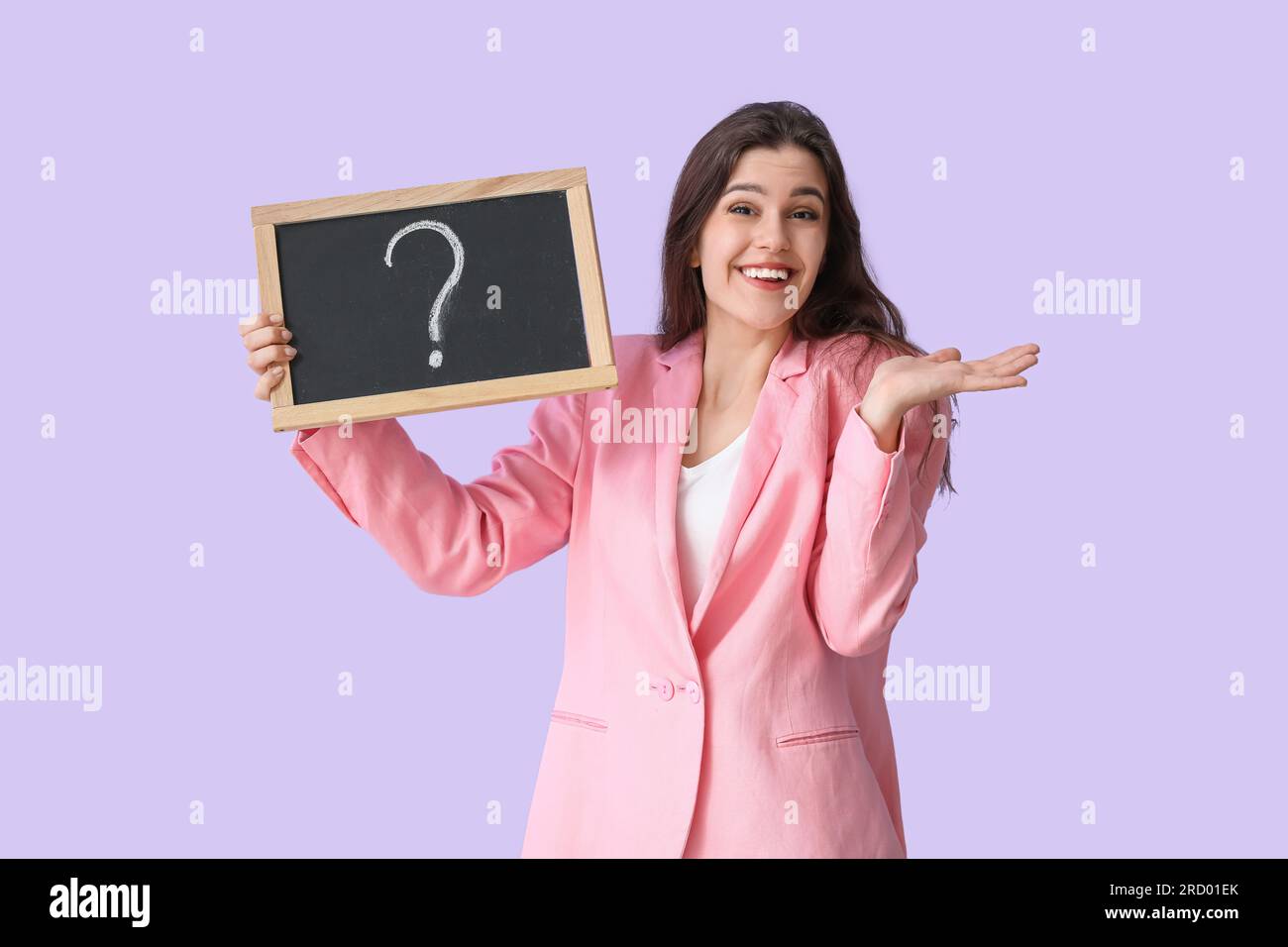 Female teacher holding chalkboard with question mark on lilac ...