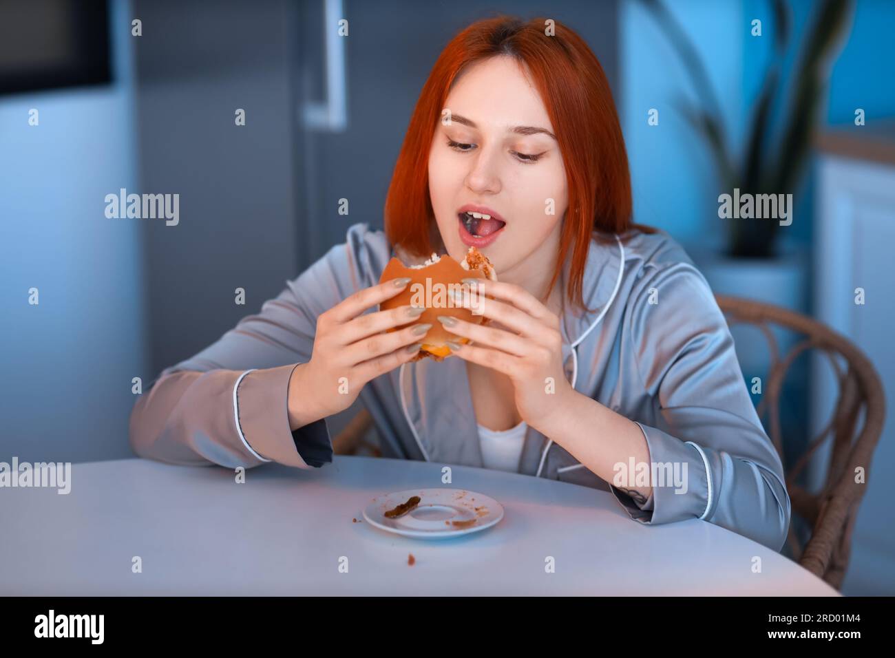Woman eating burger night hi-res stock photography and images - Alamy
