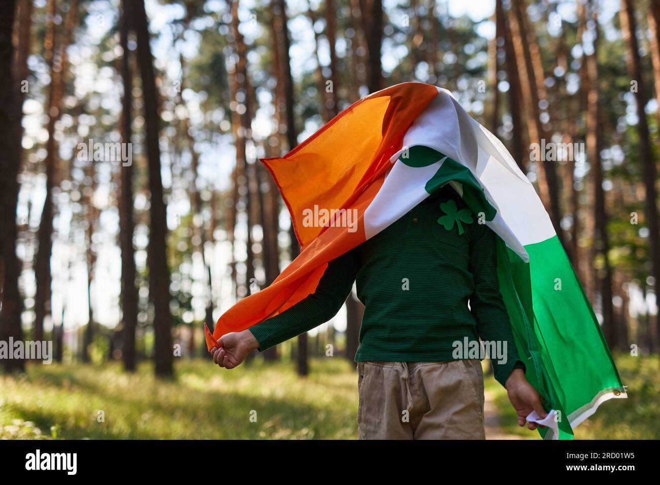 Funny little boy covered with flag of Ireland. Cute kid playing in the ...