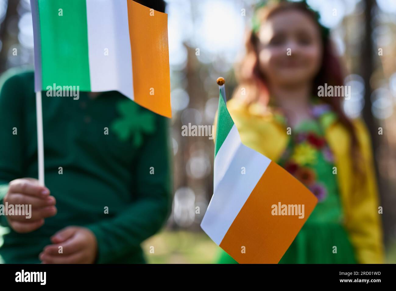 Kids celebrating St Patricks Day with Irish flags in hands. Close up ...
