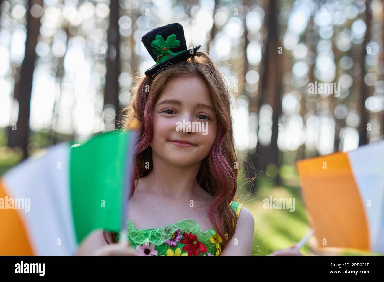 Cute little girl celebrates St Patricks Day. Portrait of a happy ...