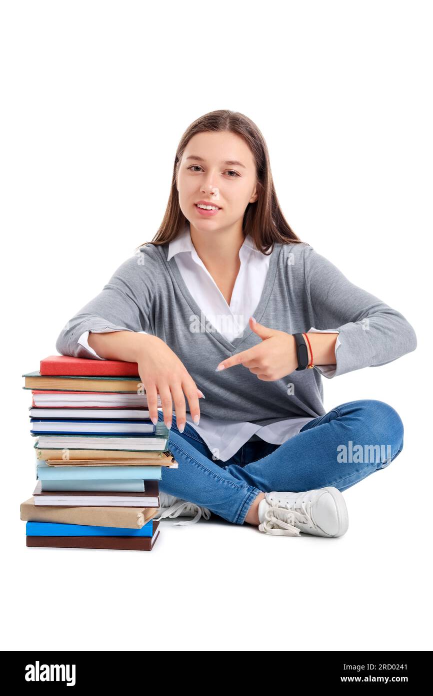 Female student pointing at books on white background Stock Photo - Alamy