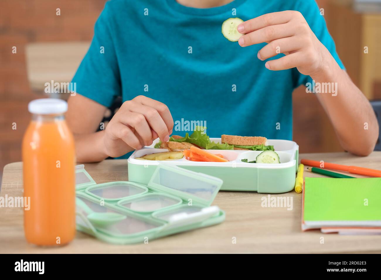 Little boy eating lunch in classroom, closeup Stock Photo - Alamy
