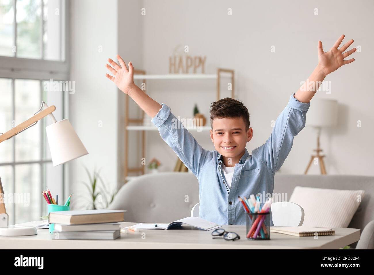 Happy little boy doing lessons at home Stock Photo - Alamy