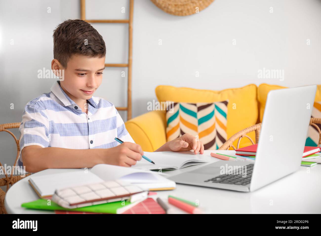 Little boy studying online with laptop at home Stock Photo - Alamy