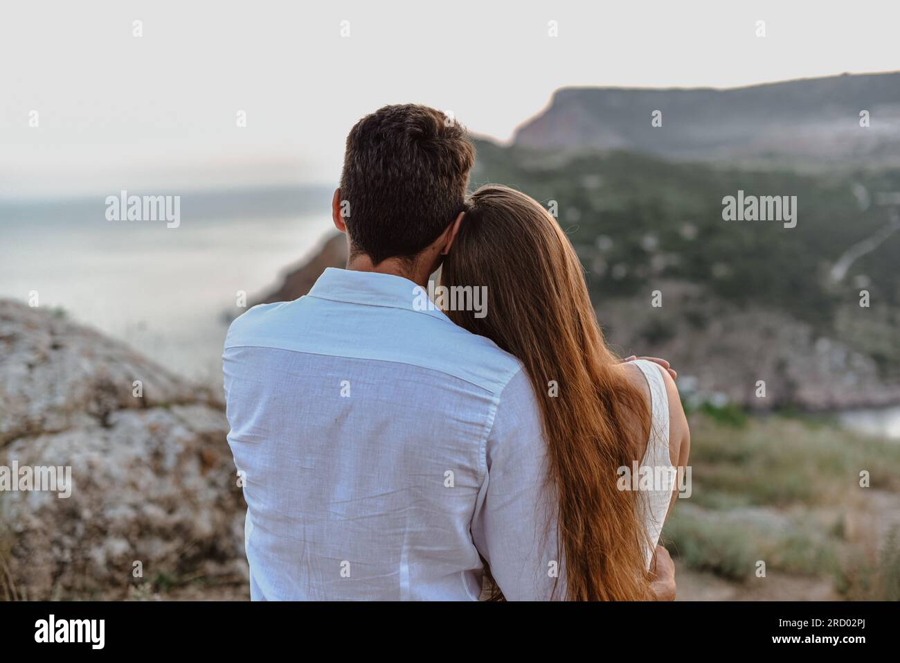 Beautiful young loving couple man of Middle Eastern appearance and a Caucasian woman hug, kiss ...