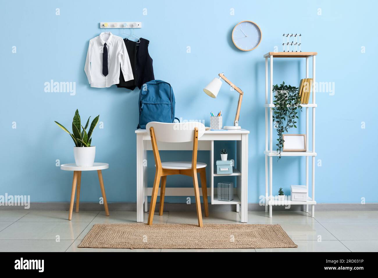 Interior of workplace with desk, shelving unit, clock and stylish ...