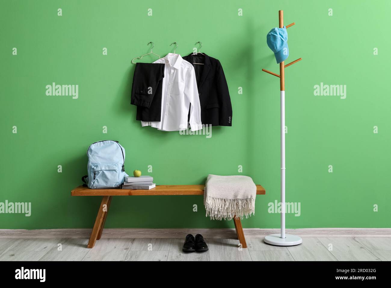 Rack with cap, bench, backpack, shoes and stylish school uniform ...