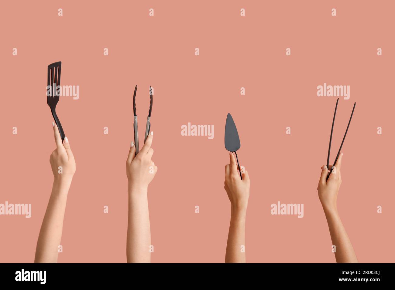 Female hands with spatulas and tongs on pink background Stock Photo - Alamy