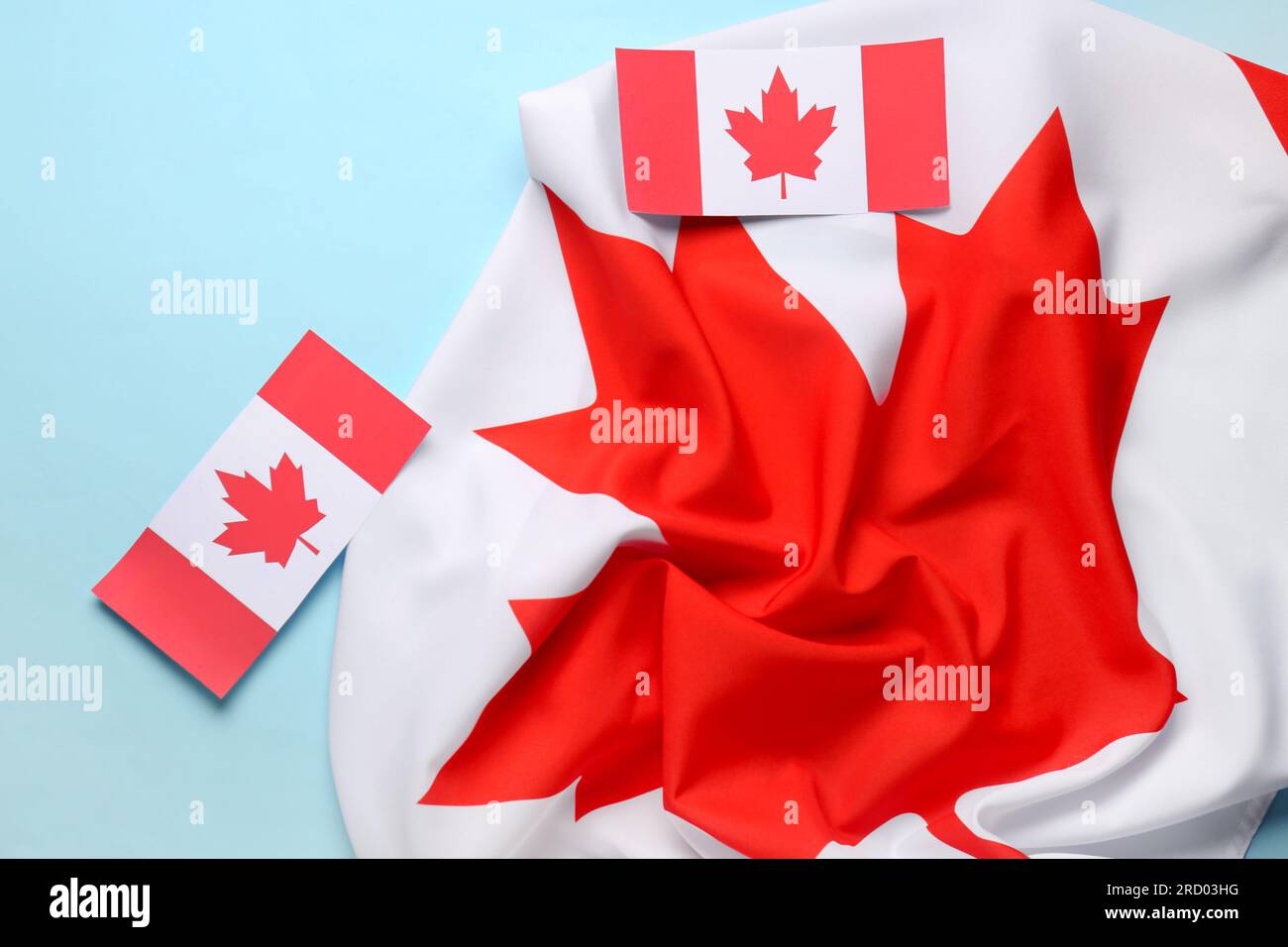 Flags of Canada on blue background Stock Photo - Alamy