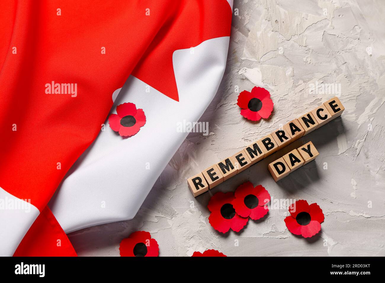 Poppy flowers with flag of Canada on grunge grey background ...