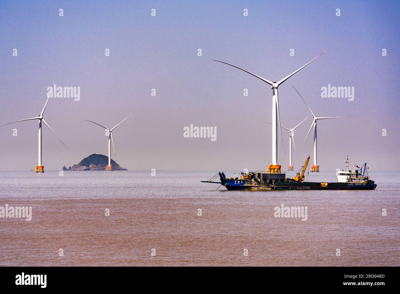 A dredger and wind turbines in the East Sea near Shanghai’s Yangshan ...