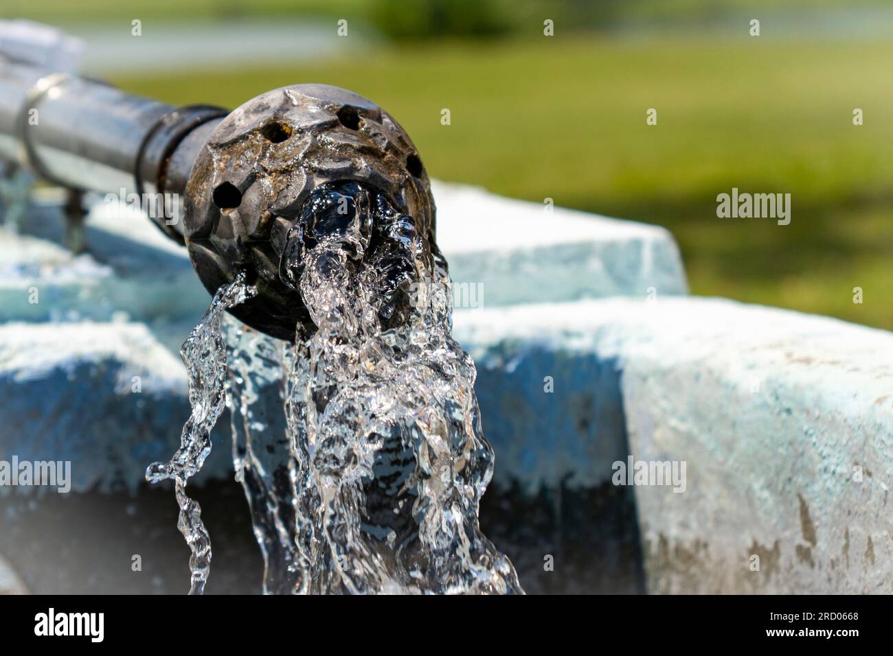 Sparkling crystal clear water flowing from an old well Stock Photo - Alamy