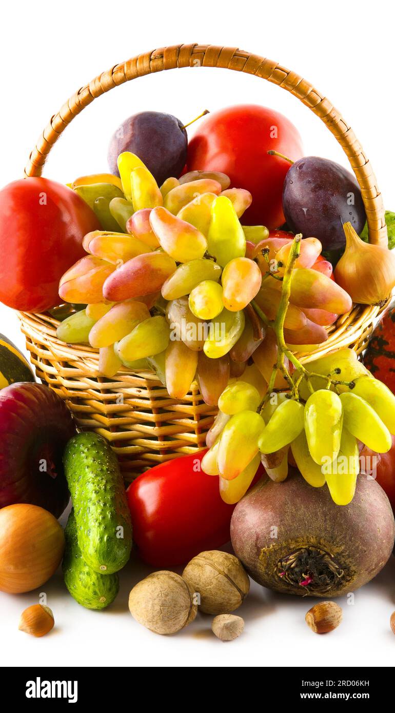 Fruits and vegetables in a basket isolated on a white background ...