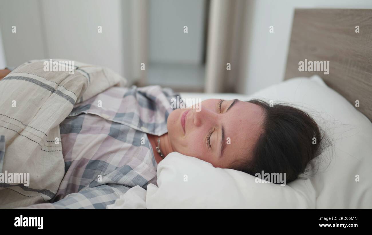 Mother wakes up in morning with child mom getting up from bed Stock ...