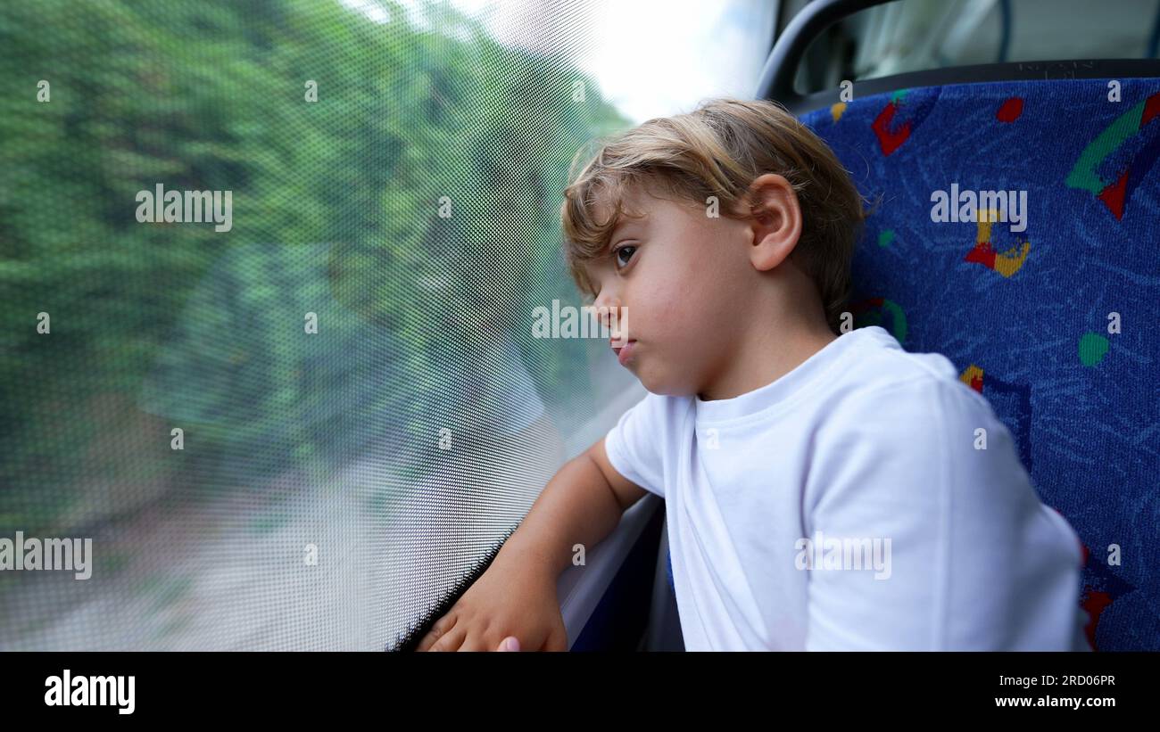 One contemplative child travels by bus leaning head on window Stock ...
