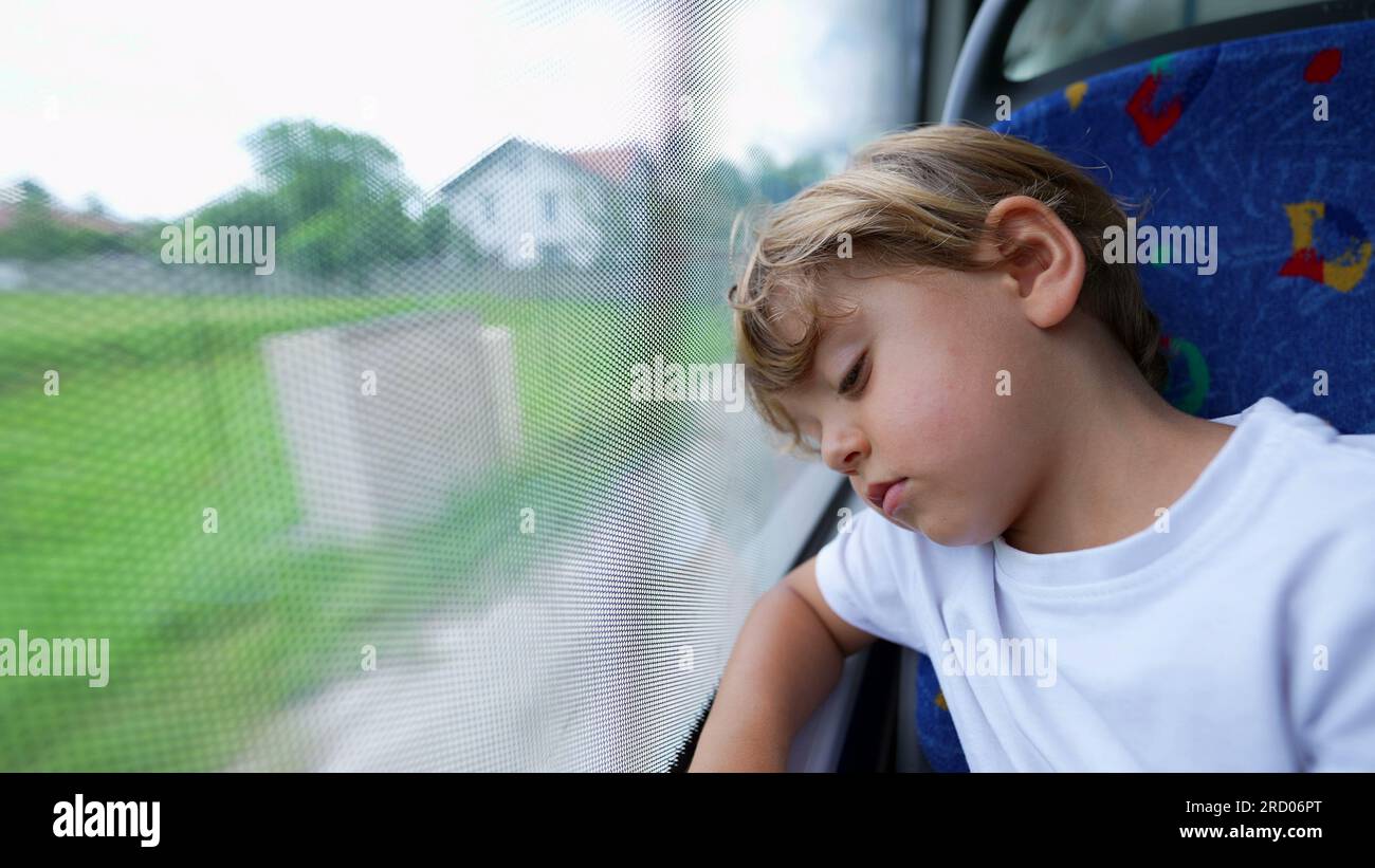 One contemplative child travels by bus leaning head on window Stock ...