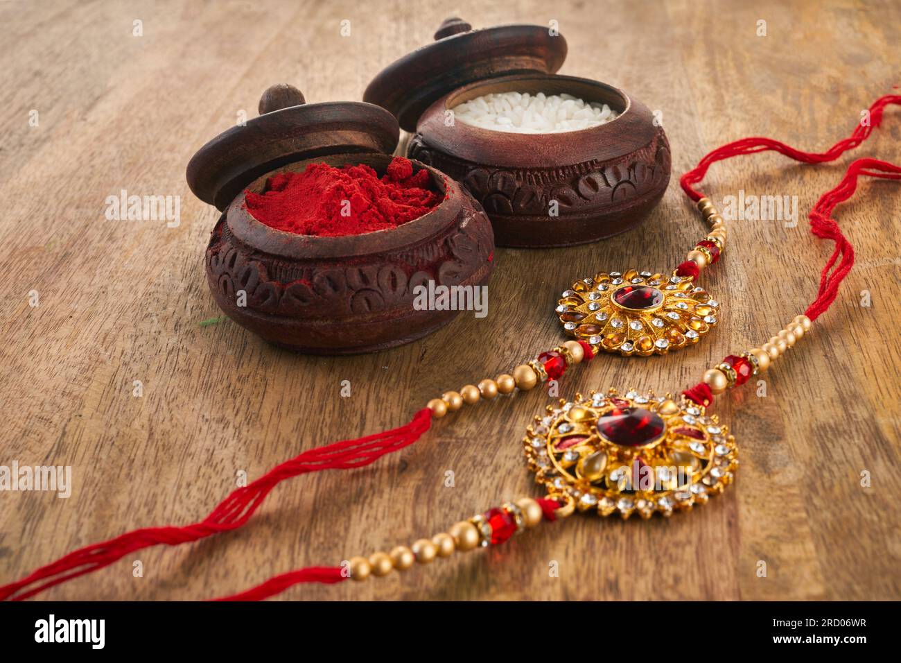 Raksha Bandhan background with Rakhi string, Rice Grains and Kumkum ...