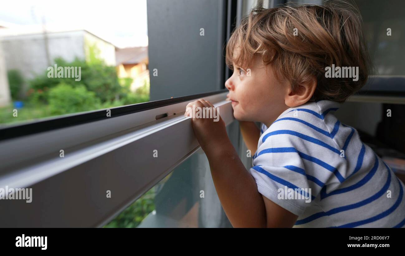 Child holding into window dangerous little boy near window wanting to ...
