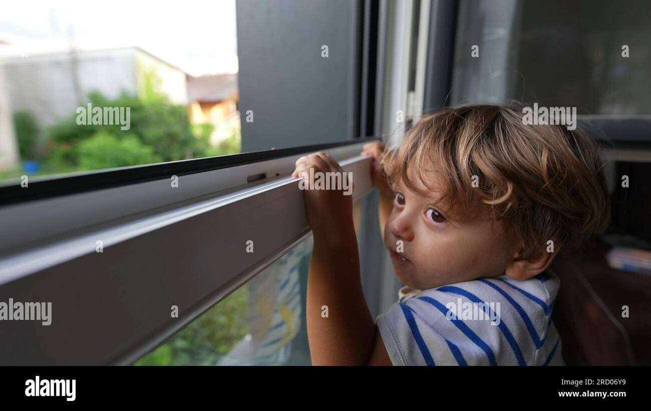 Child holding into window dangerous little boy near window wanting to ...