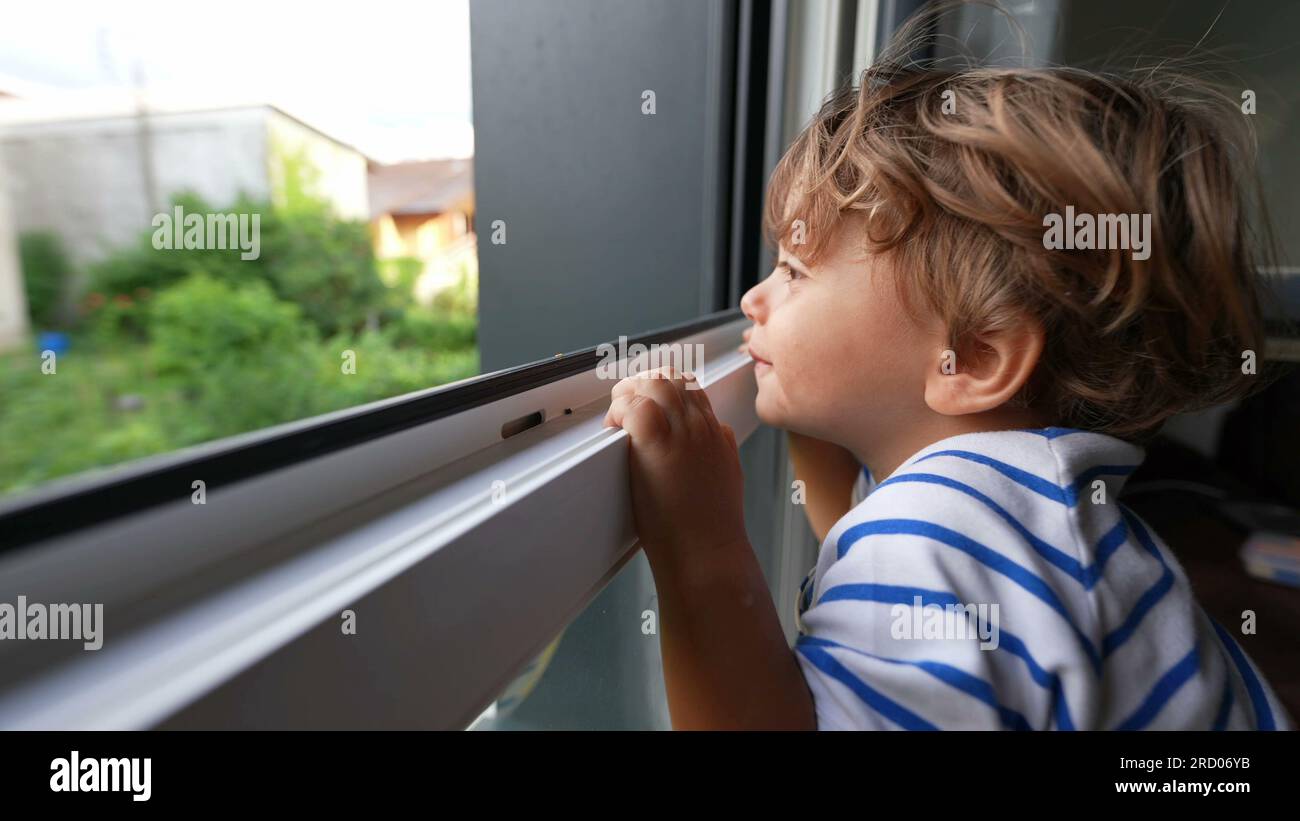 Child holding into window dangerous little boy near window wanting to ...