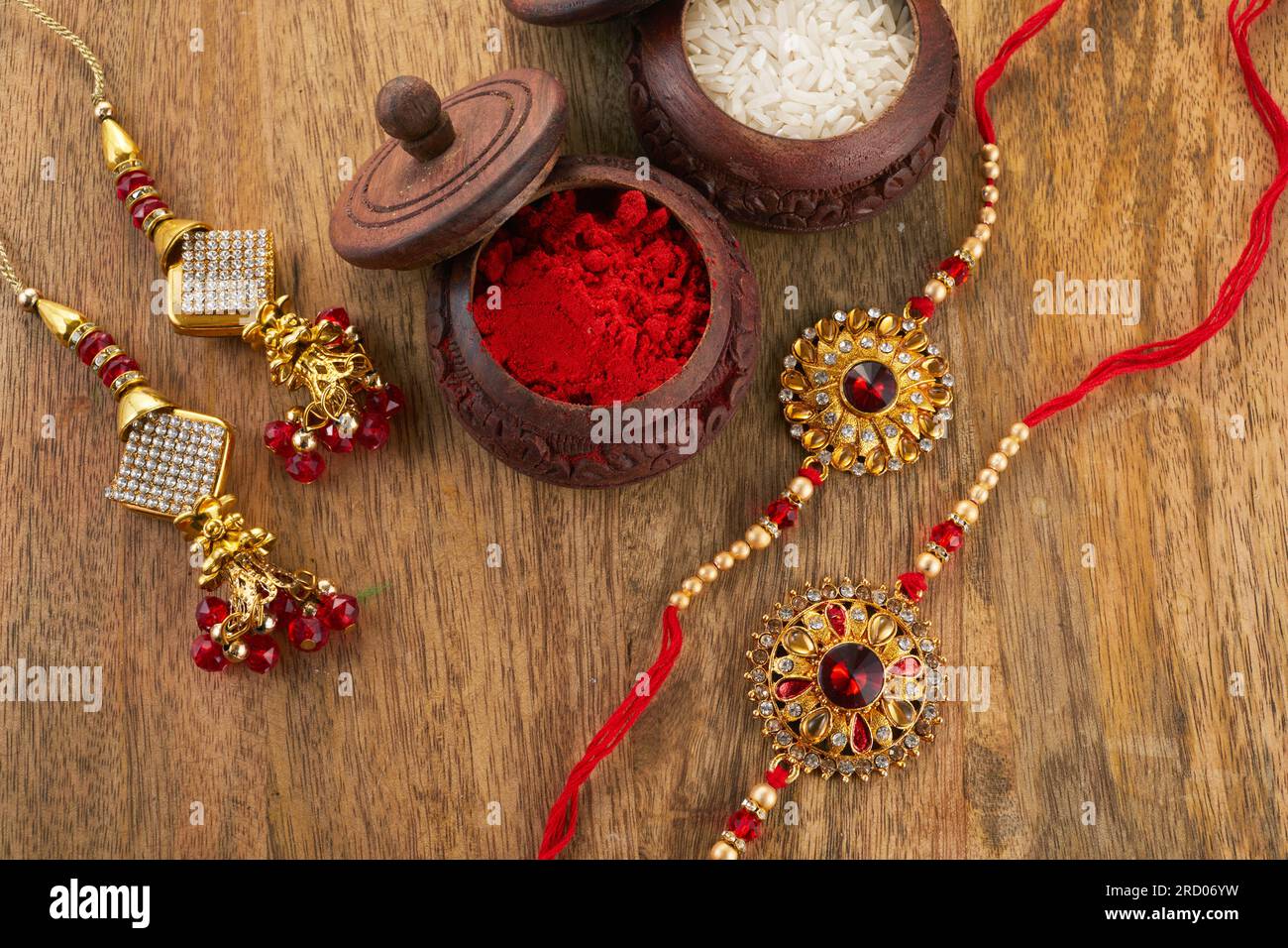 Raksha Bandhan background with Rakhi string, Rice Grains and Kumkum ...