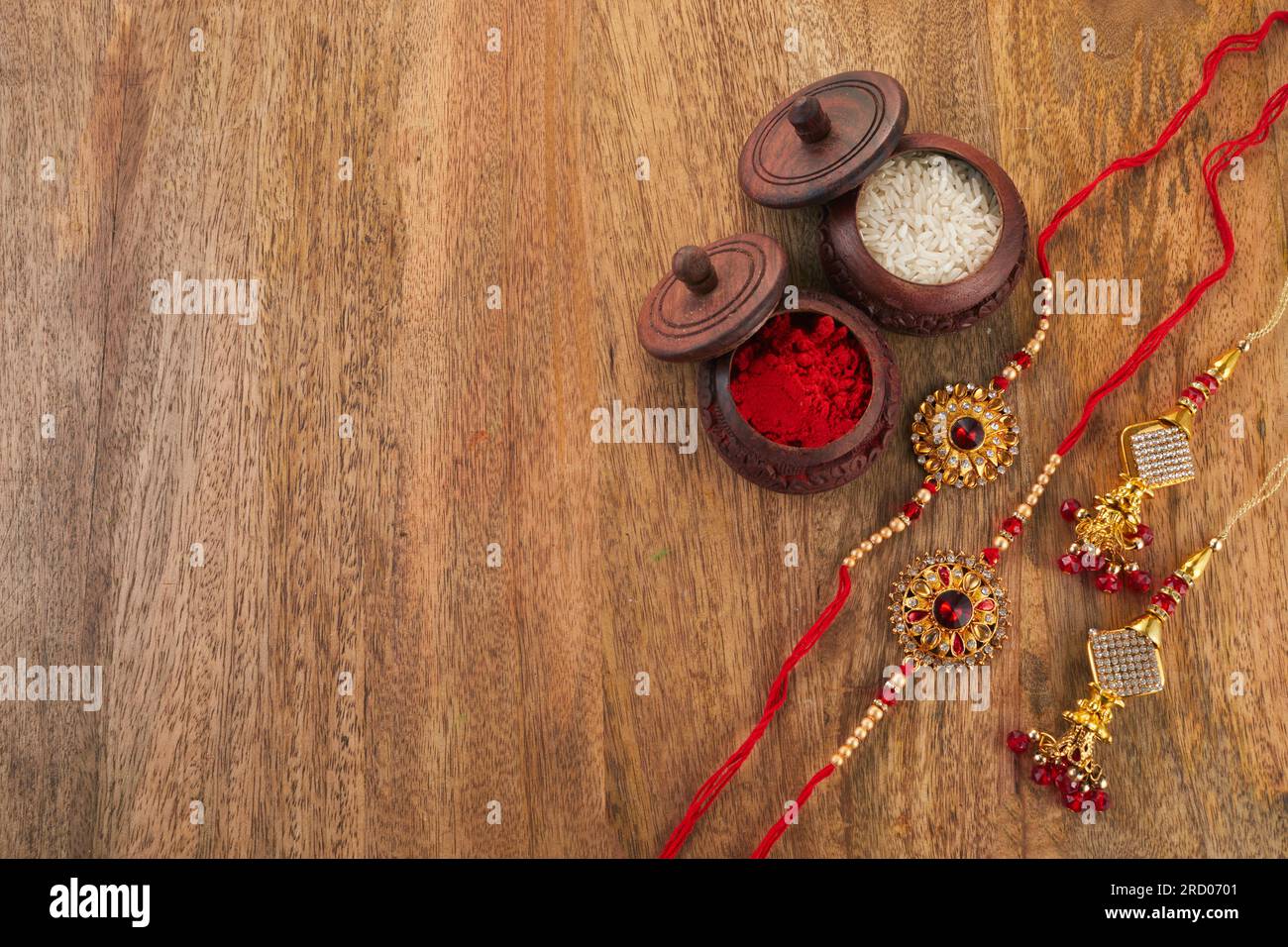 Raksha Bandhan background with Rakhi string, Rice Grains and Kumkum ...