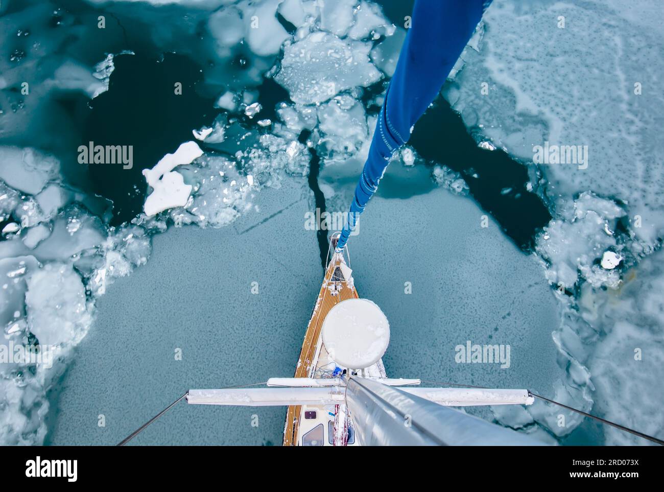 Sailboat breaking ice in bay Patagonia. Top view of the boat taken from ...