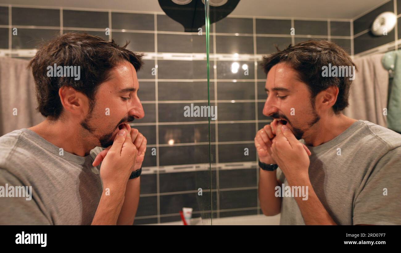 Man applying lotion cleanser washing face in front of mirror Stock ...
