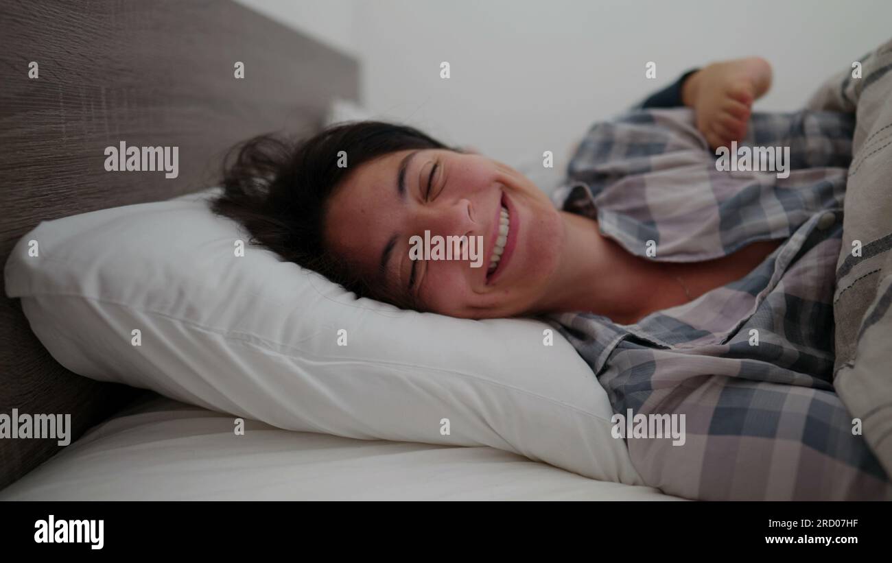 Mother in bed with child waking up in the morning yawning starting the ...