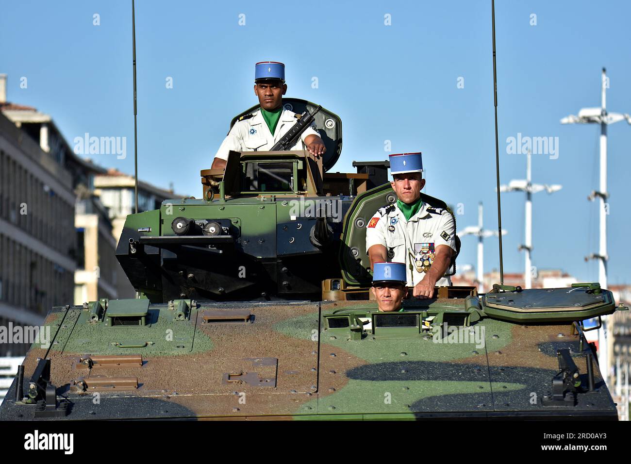 Soldiers on an armored military vehicle equipped with a cannon parade ...
