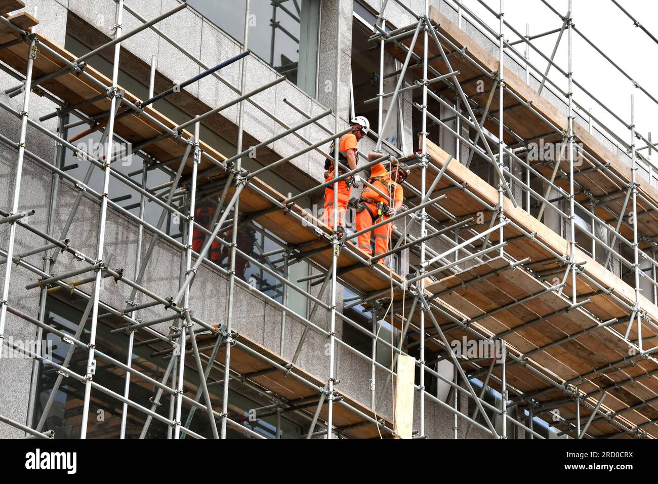 London, England, UK - 27 June 2023: Construction workers pulling a ...