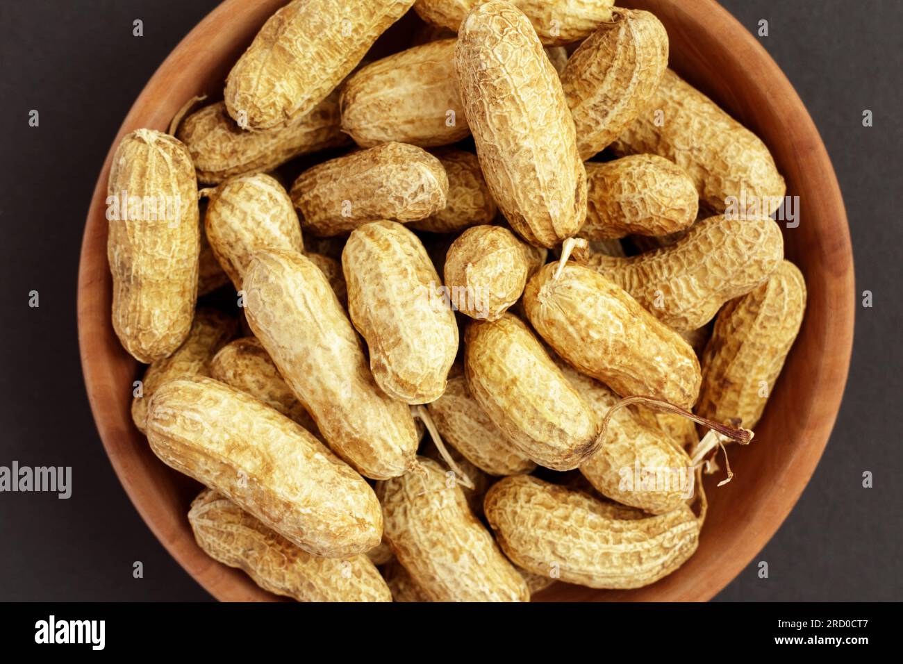 Roasted peanuts, peanuts in shell Isolated on black background Stock ...