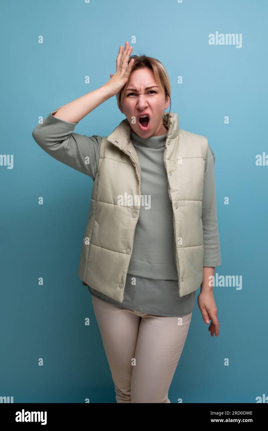 Forgetful angry blond 30 year old woman in casual clothes experiencing ...