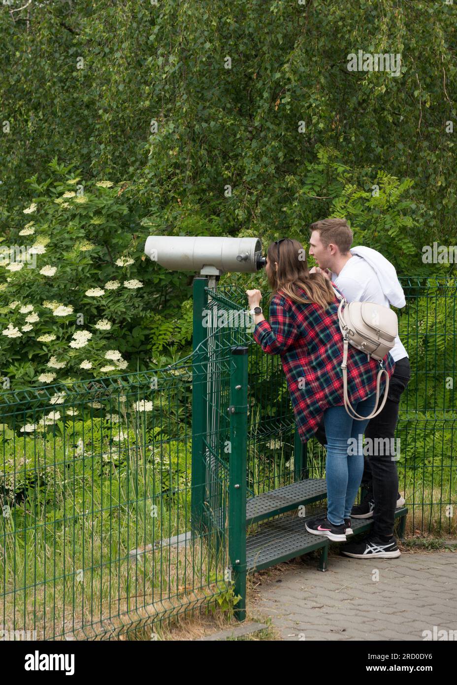 Visitors of the Gdansk Zoo watching the Lion's den through a tourist ...
