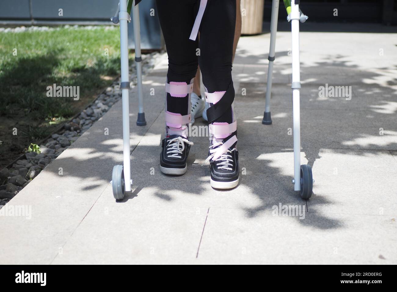child with walking frame and knee orthosis outdoor Stock Photo - Alamy