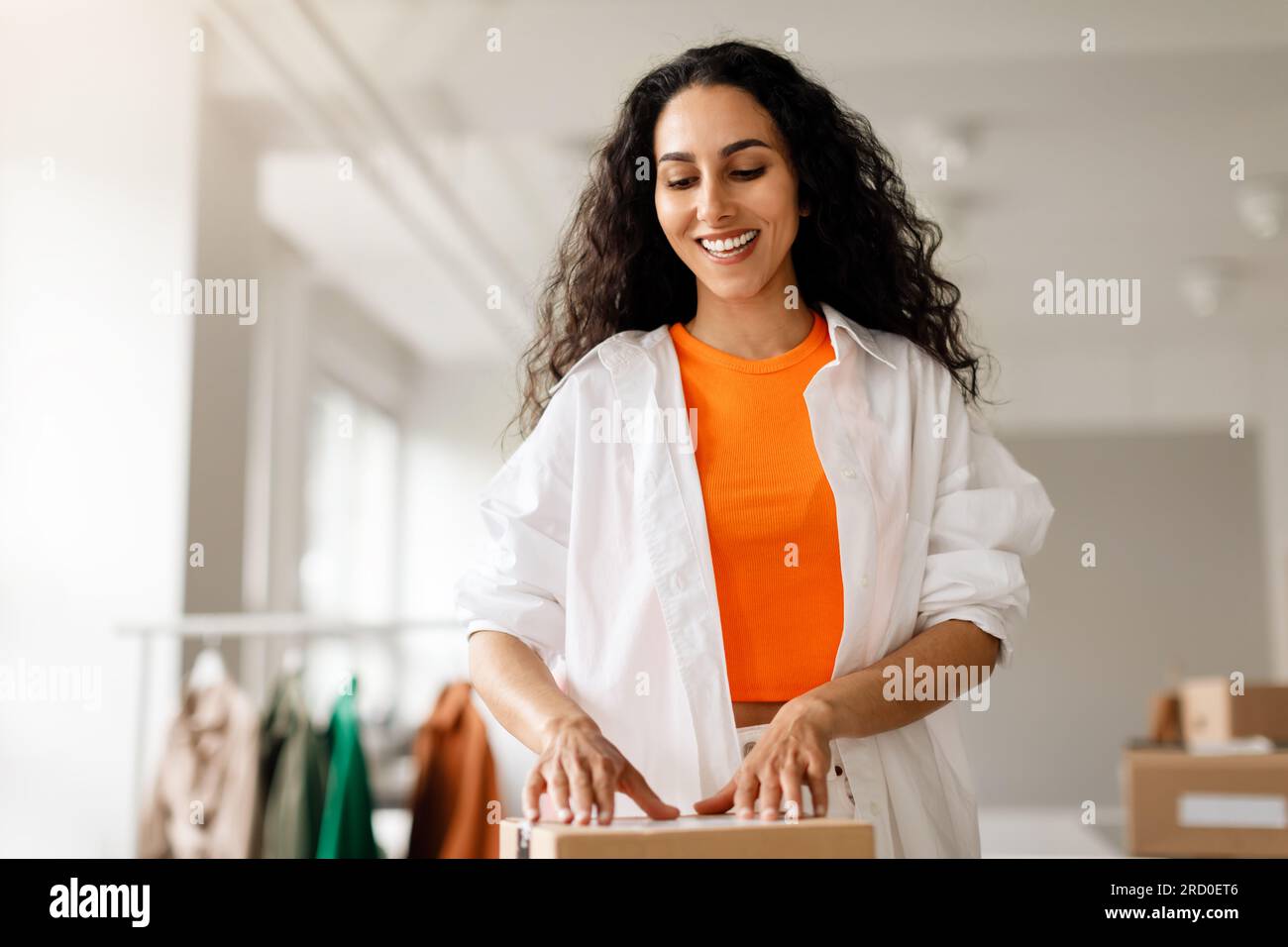 Arabic Woman Designer Preparing Parcel Packing Box In Clothing Boutique ...