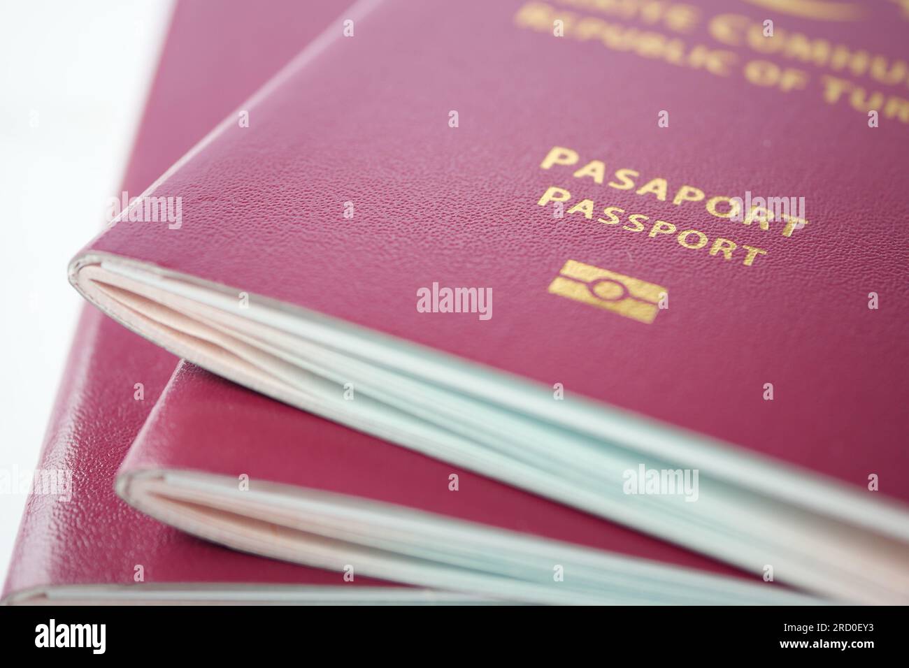 stack of red color passport on table Stock Photo - Alamy