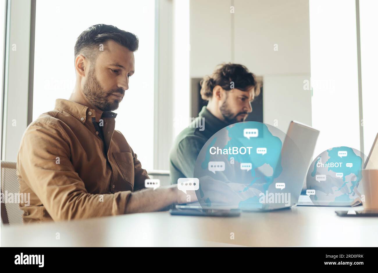Concentrated IT employee using chatbot while working in team Stock ...