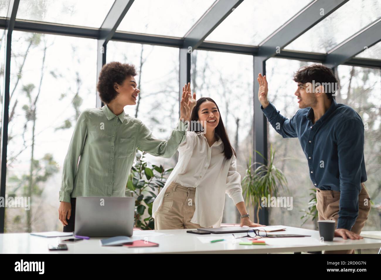 Multicultural Colleagues Team Celebrates Achievement with High Five In ...
