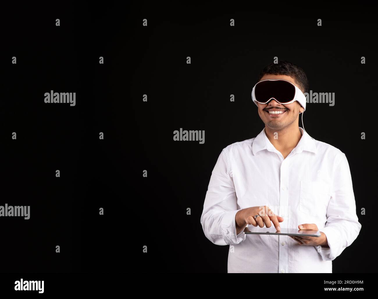 Male CGI artist drawing using graphics tablet and vision pro vr glasses ...