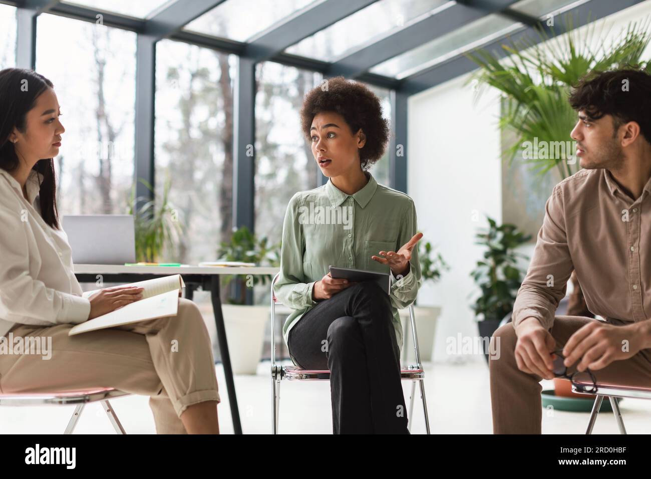 Diverse coworkers engaging in discussion hi-res stock photography and ...