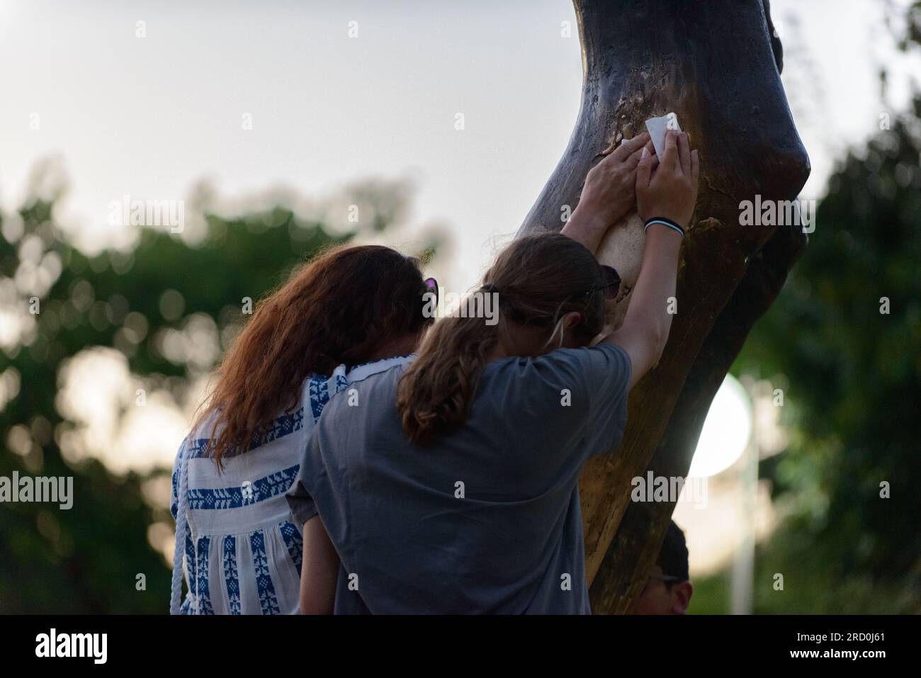 People venerating the statue of the Risen Christ in Medjugorje. The ...